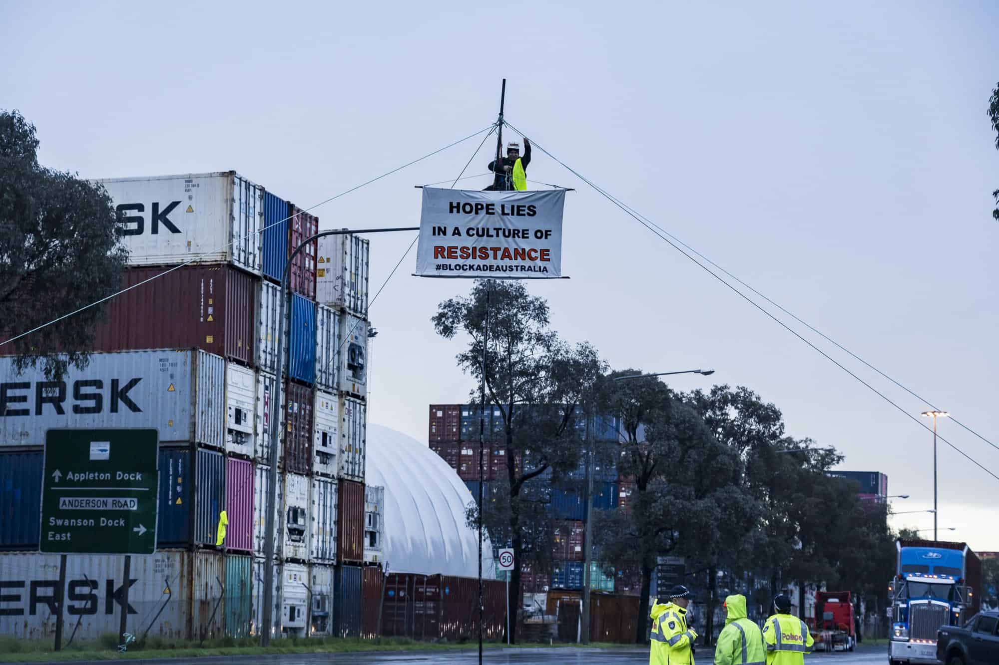 Activist hangs from monopole to block Port of Melbourne - Blockade ...